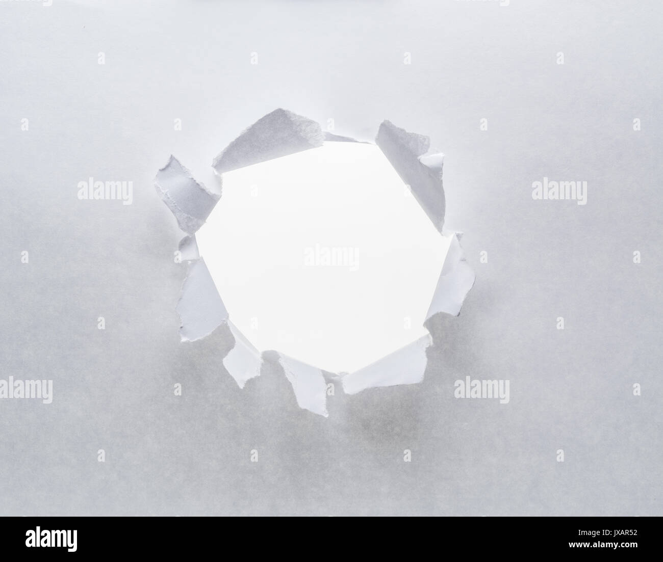 Hole on a paper. White background Stock Photo - Alamy