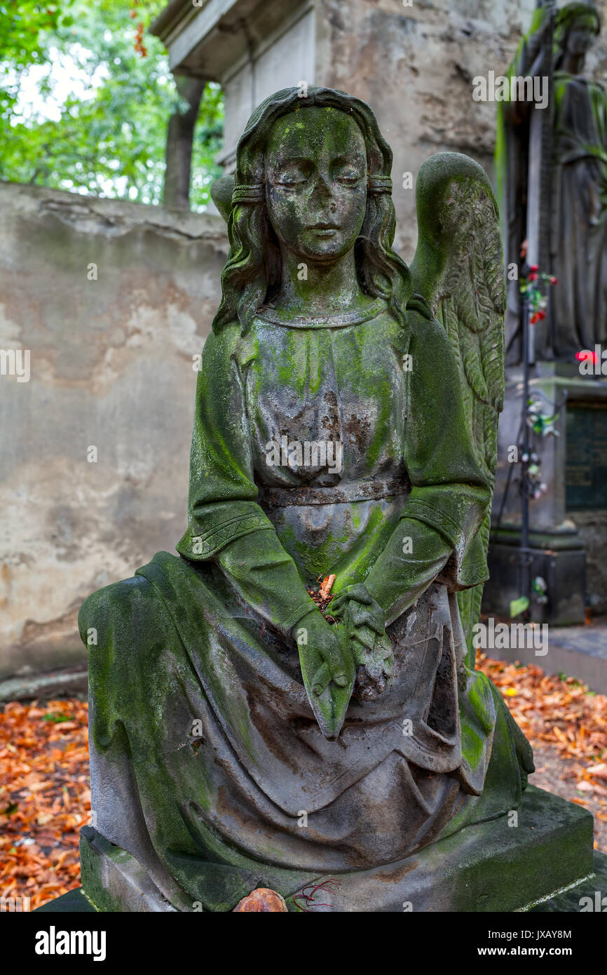 Antique stone statue of little girl on famous old Olsanske cemetery in ...