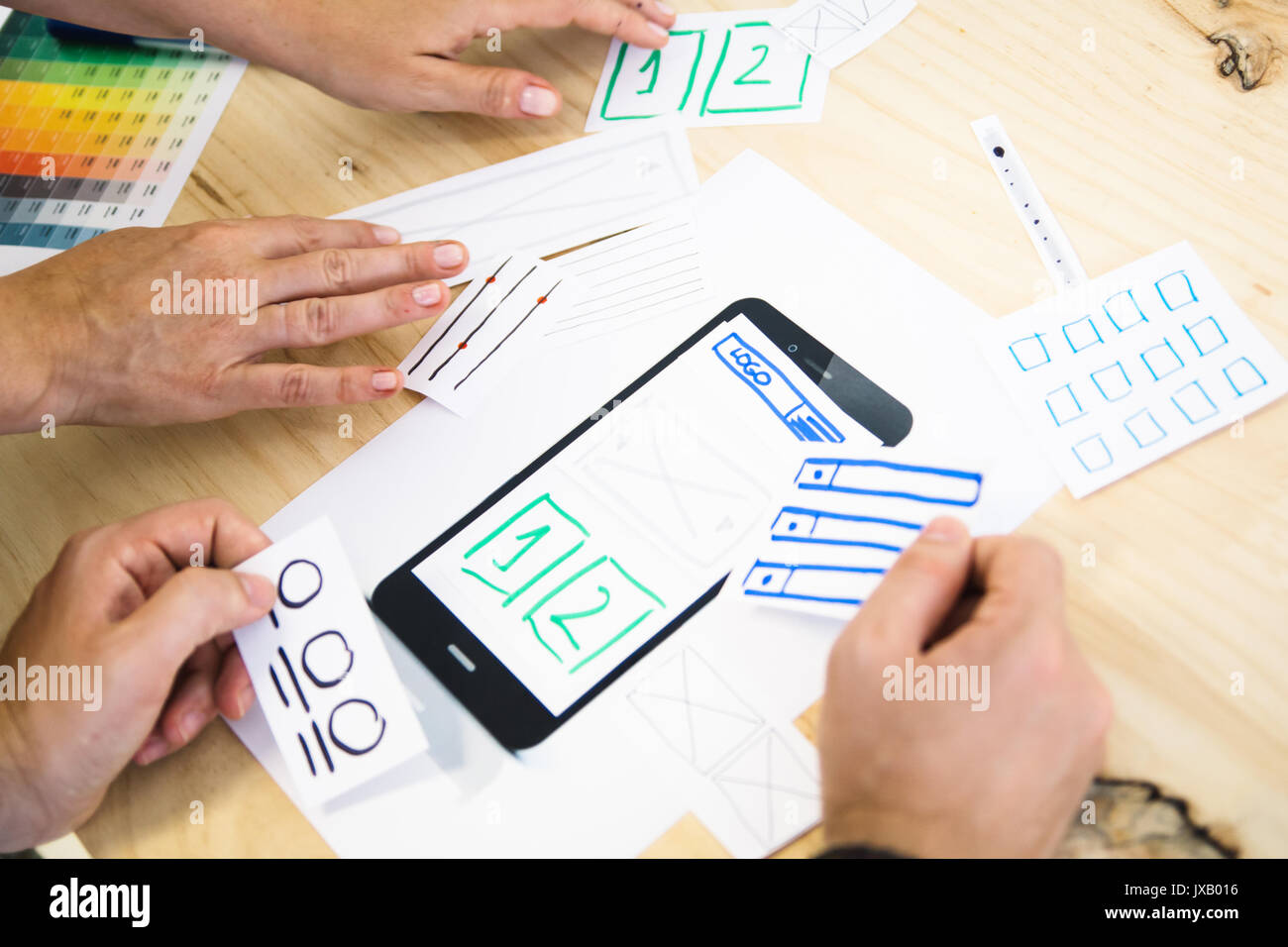 Mobile app design concept hands Stock Photo - Alamy