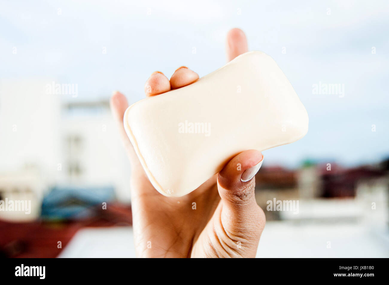 Woman's hand holding soap Stock Photo - Alamy