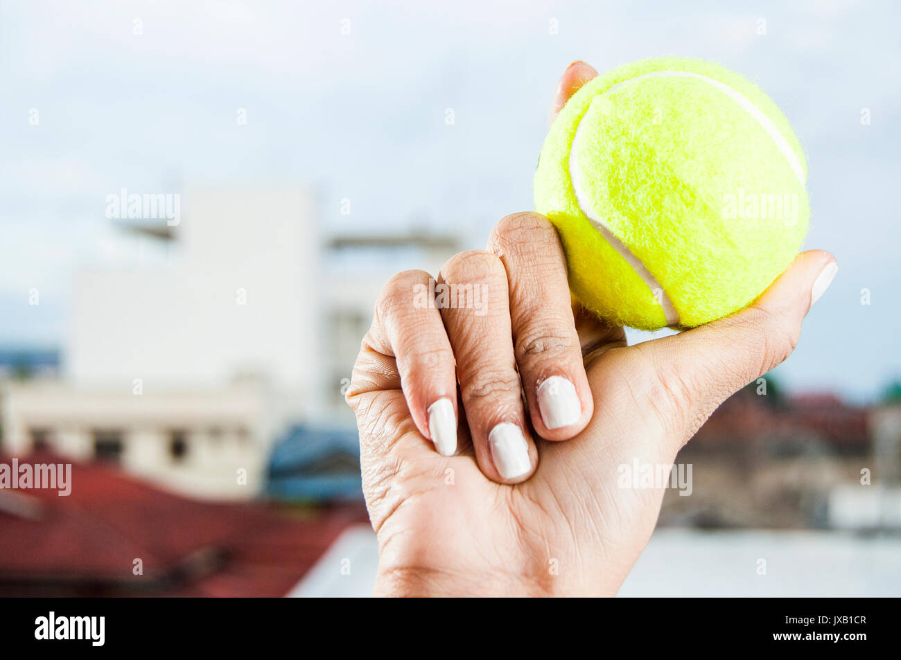 Woman's hand holding tennis ball Stock Photo - Alamy