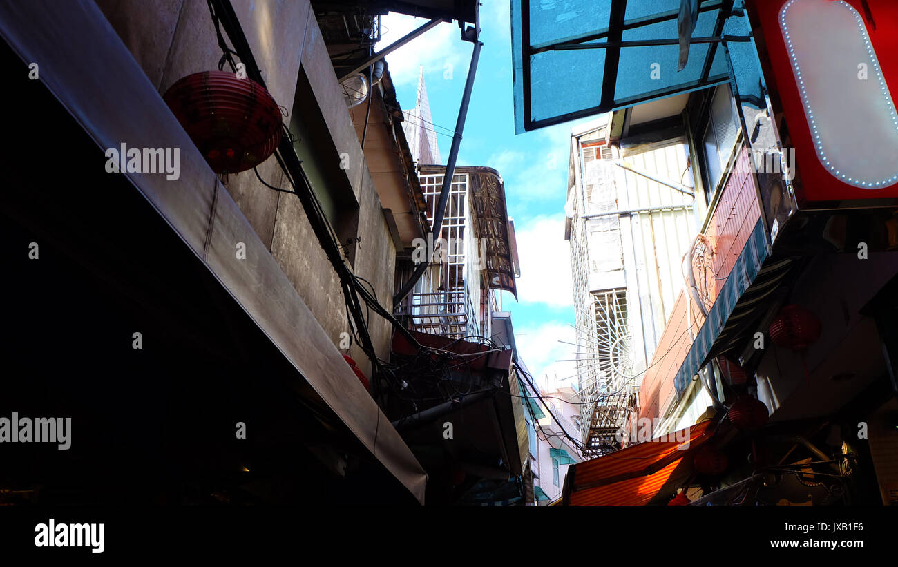 Exterior of the narrow shop lots building Taiwan, with clear blue sky ...