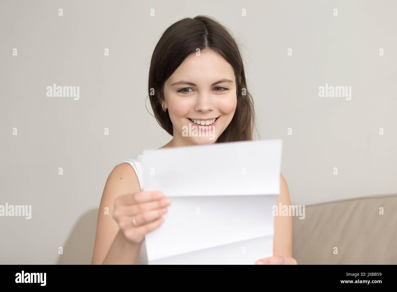 Surprised woman reading letter with unexpected good news, feelin Stock ...