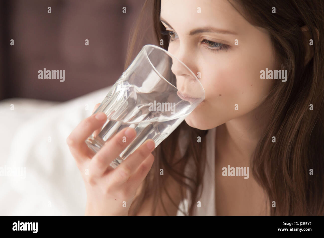 Young dehydrated woman feeling thirsty, drinking mineral water f Stock ...