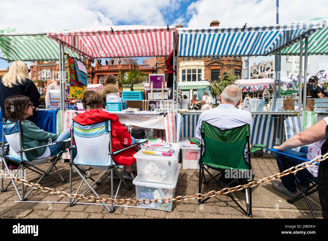 English market. Stalls selling handicrafts, seen from behind, with ...