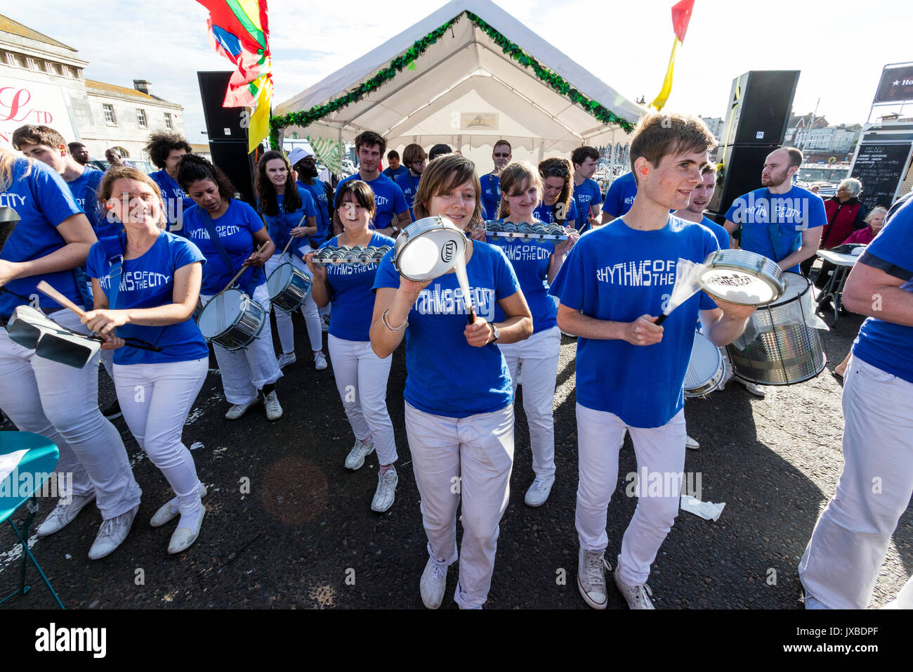 Music group Rhythms of the City samba band playing outdoors in sunshine ...