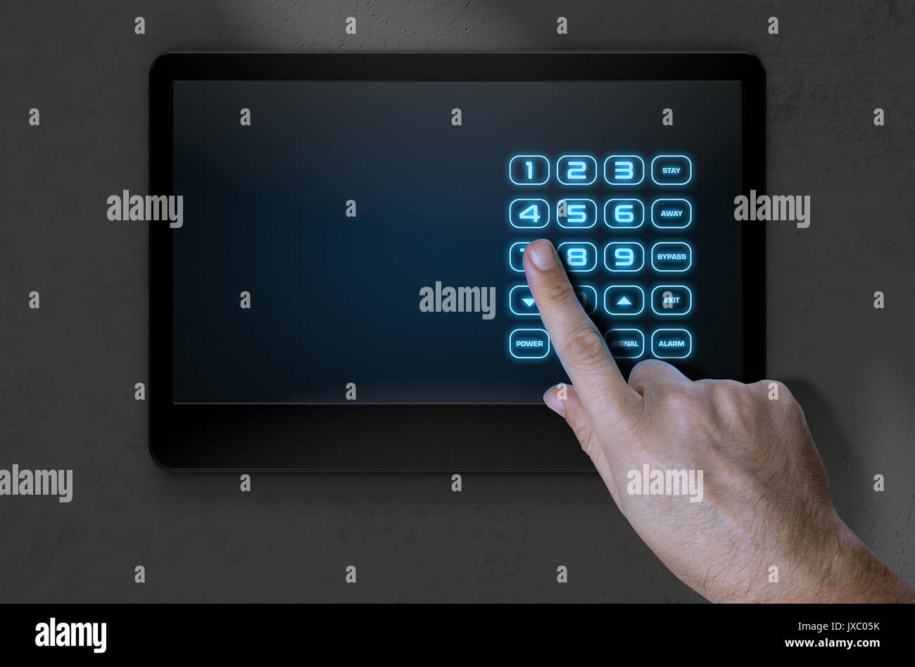 A male hand pressing the screen of a home security control panel with a ...