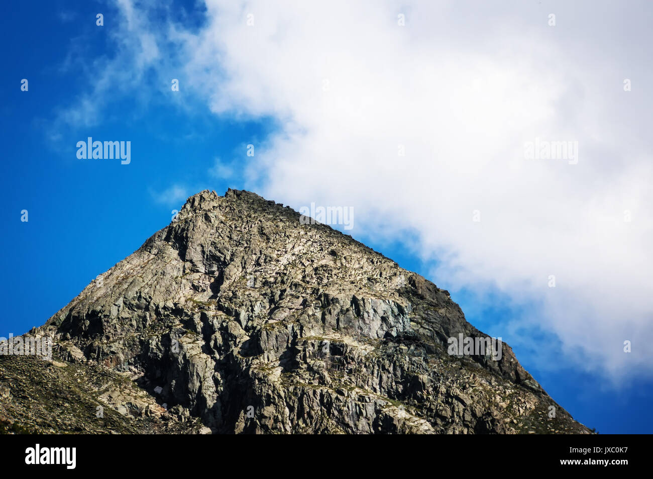 view of the summit on a blue sky background with white clouds in summer ...