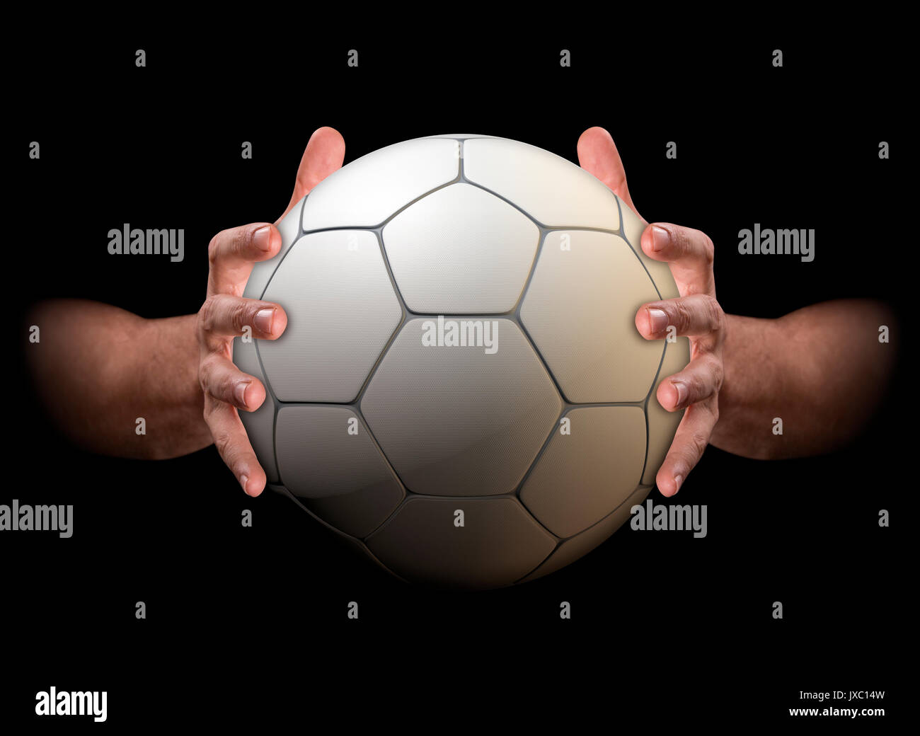 A pair of male hands clamping a soccer ball on an isolated dark ...
