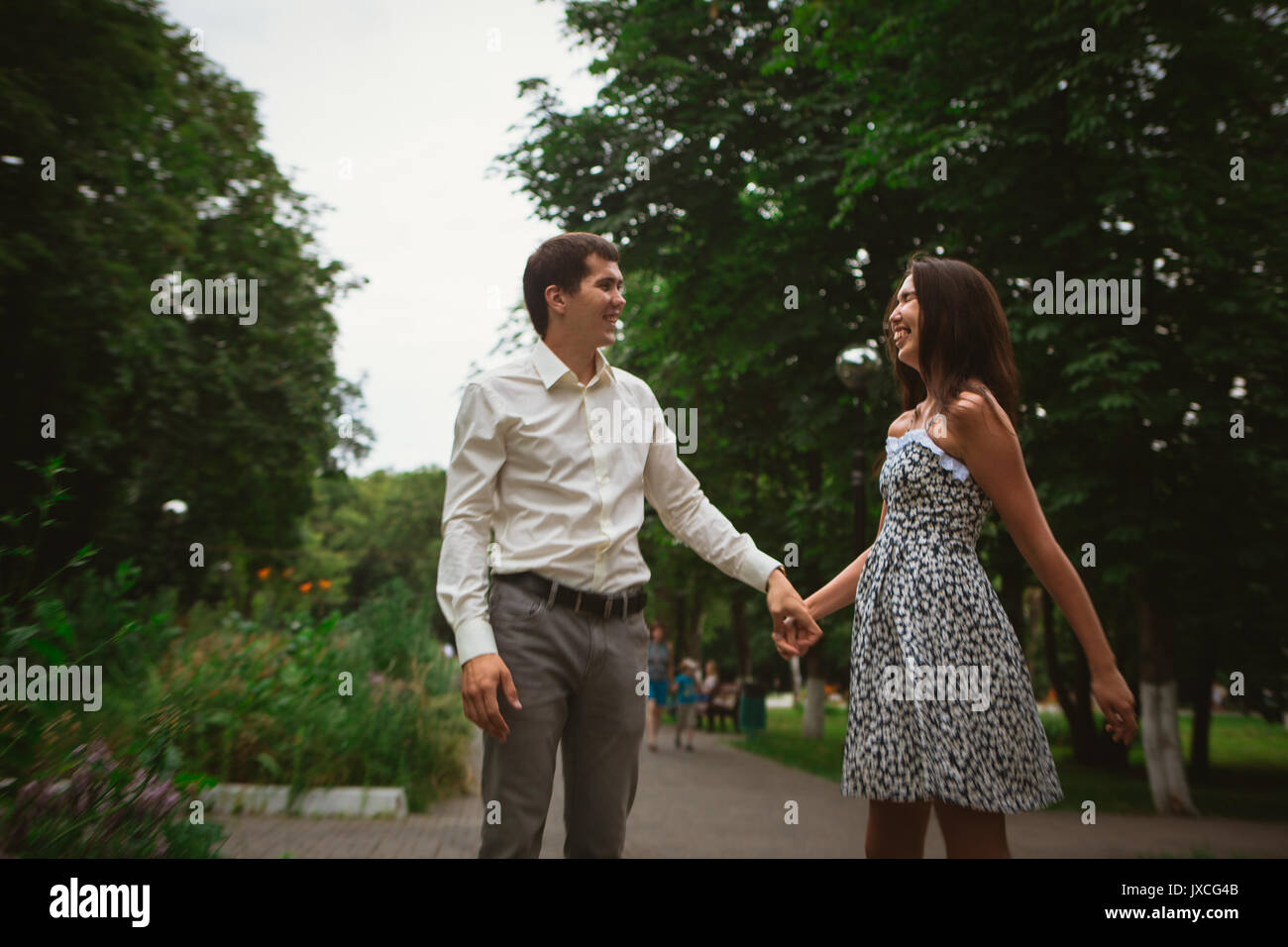Beautiful young couple on a nature background Stock Photo - Alamy