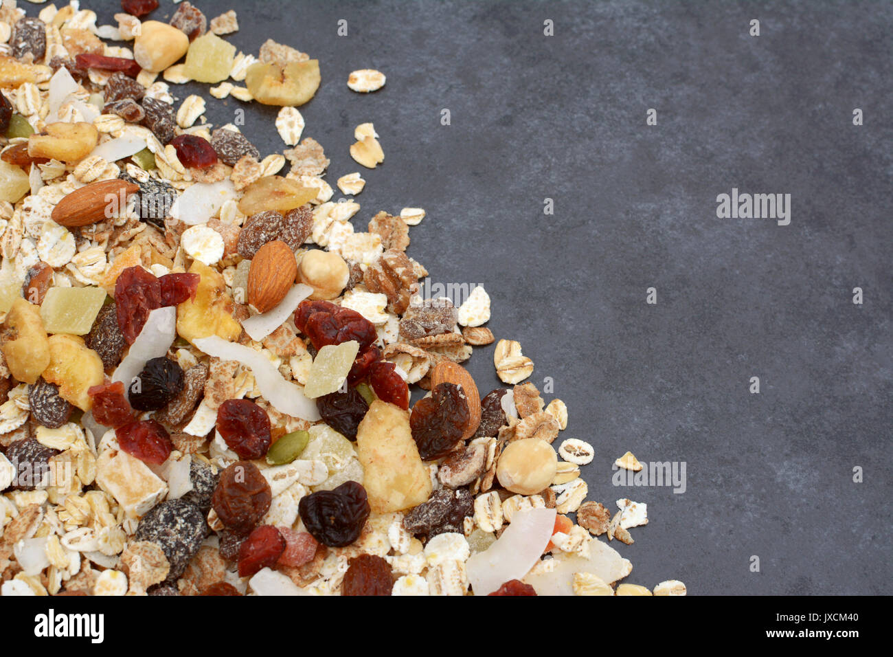 Muesli - cereal flakes with seeds, mixed fruit and nuts - in a diagonal ...