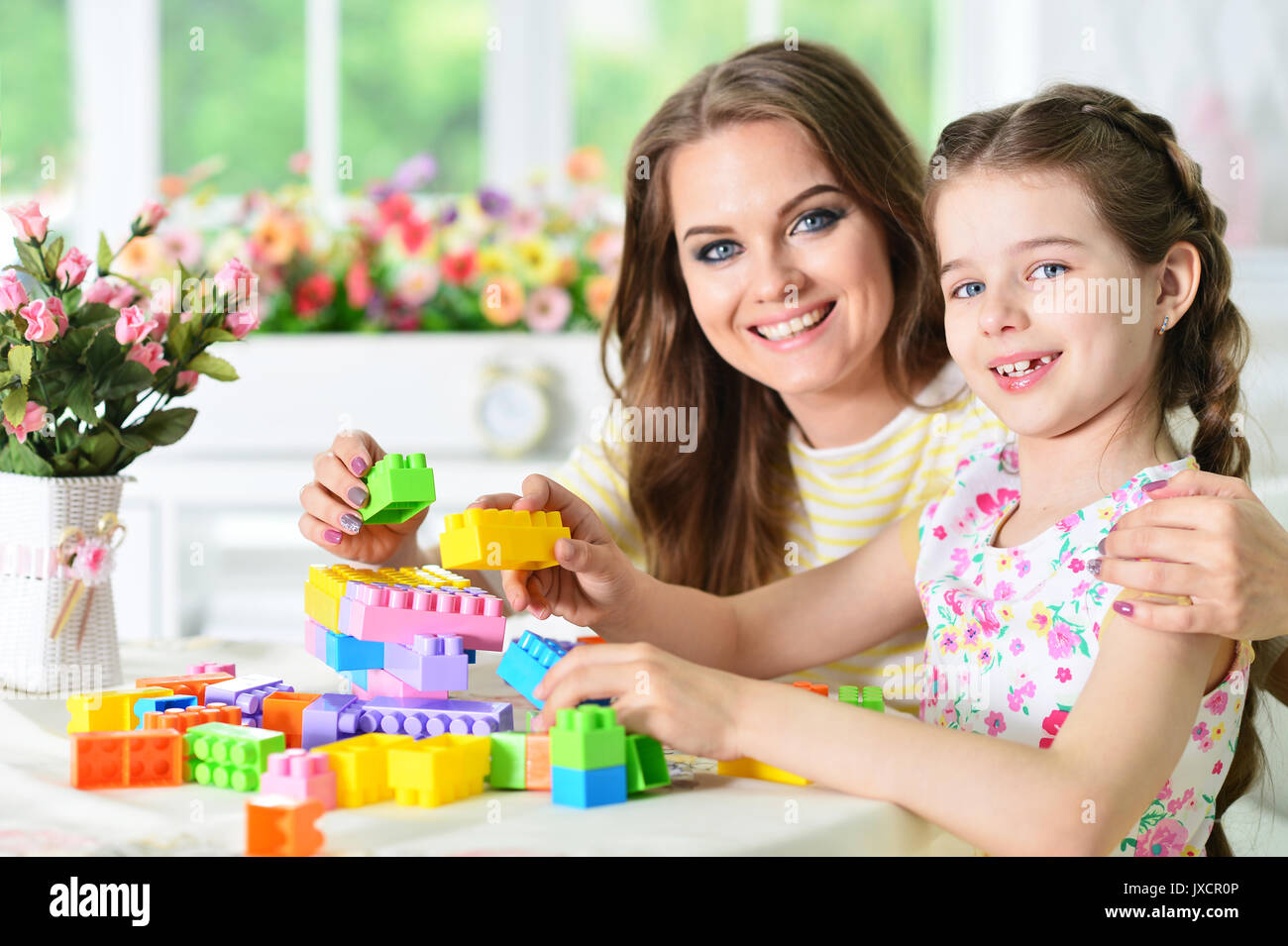 mother and daughter collecting blocks Stock Photo - Alamy