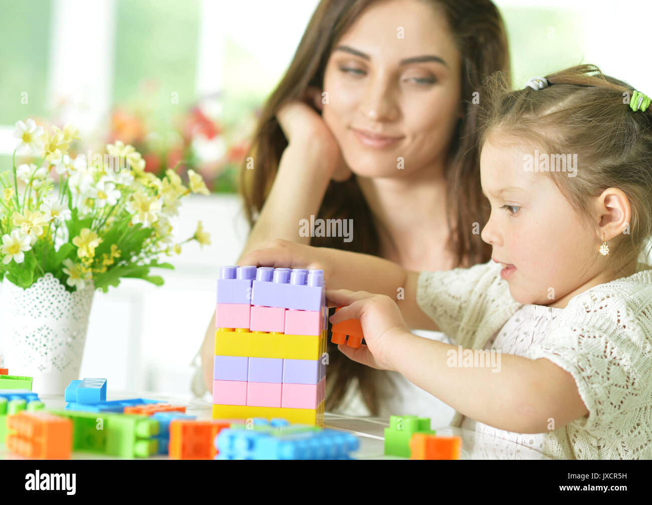 Mother and daughter with plastic blocks Stock Photo - Alamy