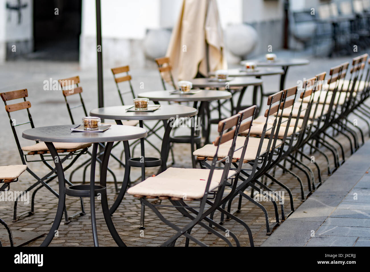 Empty coffee tables in front of the bar Stock Photo - Alamy