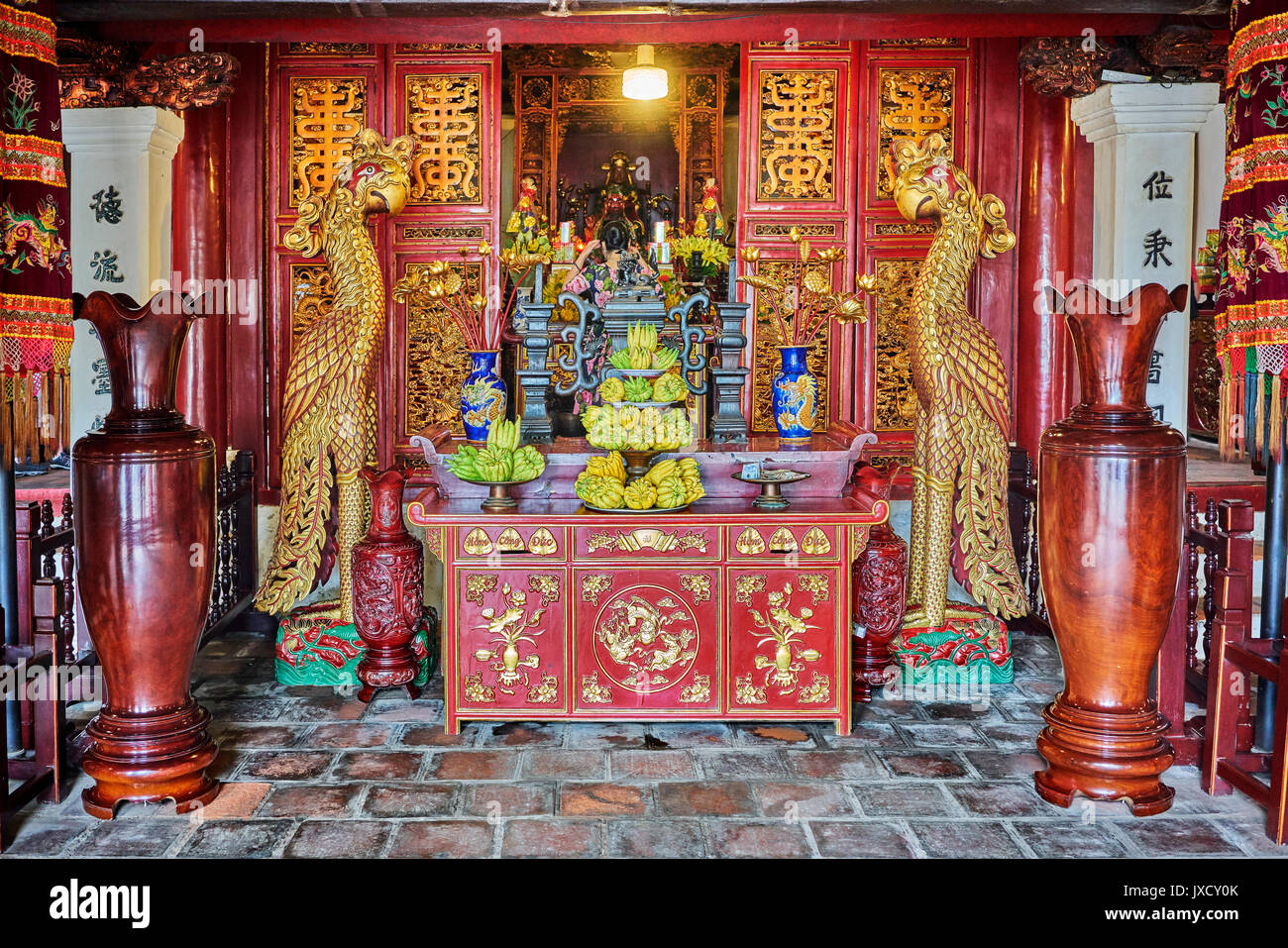 the inside of an asian temple with offerings Stock Photo - Alamy