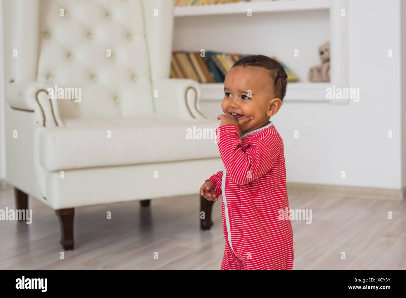 Cute curious baby study things in the room Stock Photo - Alamy