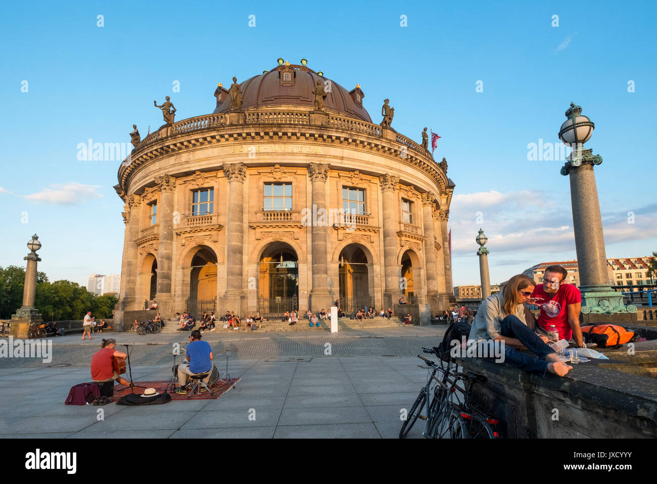 Late summer afternoon sun shining on Bode Museum with buskers and ...