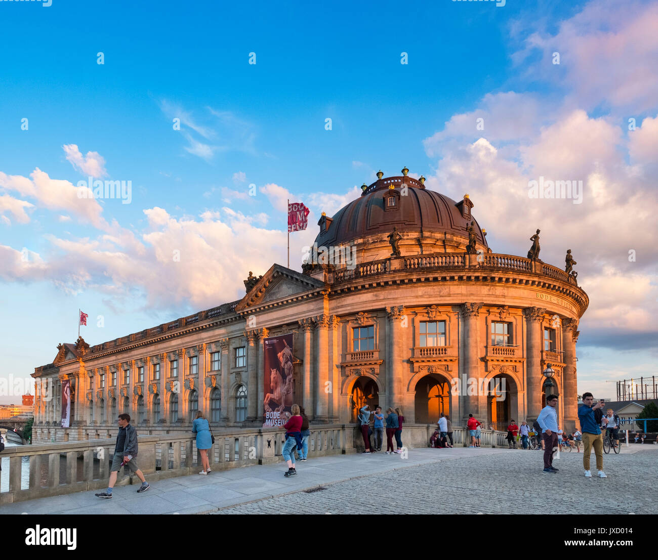 Late summer afternoon sun shining on Bode Museum with public relaxing ...