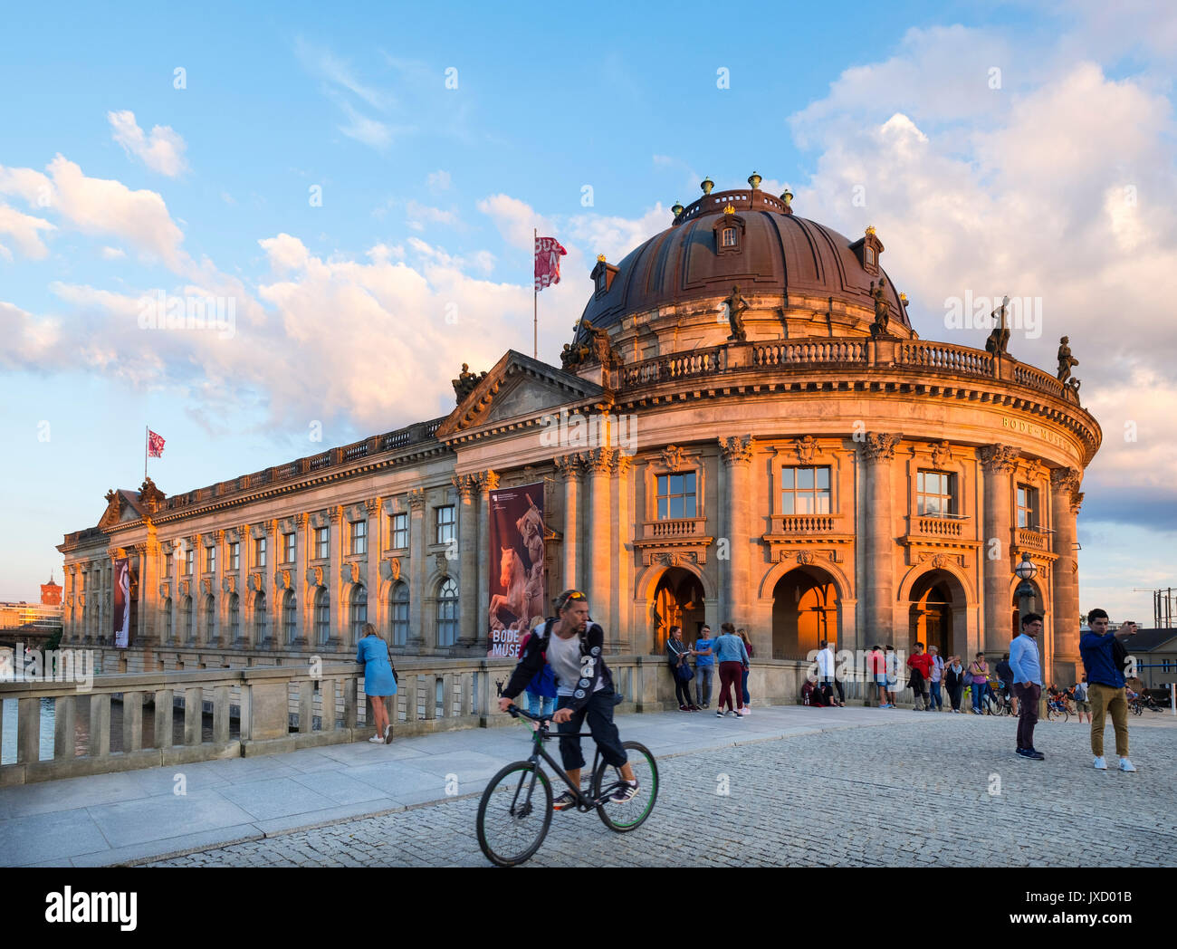 Late summer afternoon sun shining on Bode Museum with public relaxing ...