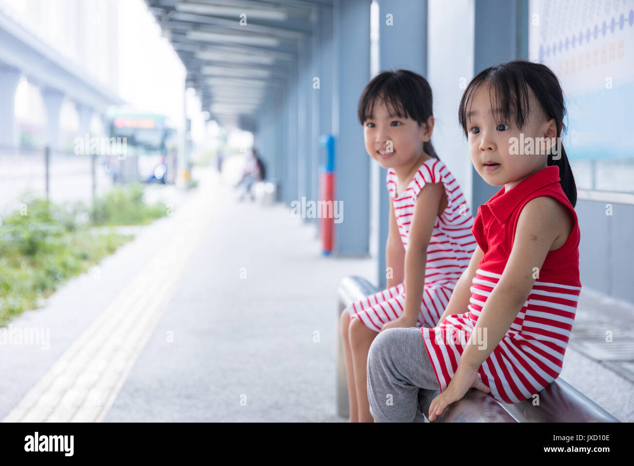 Asian Chinese little girls waiting for a bus at bus stop Stock Photo ...