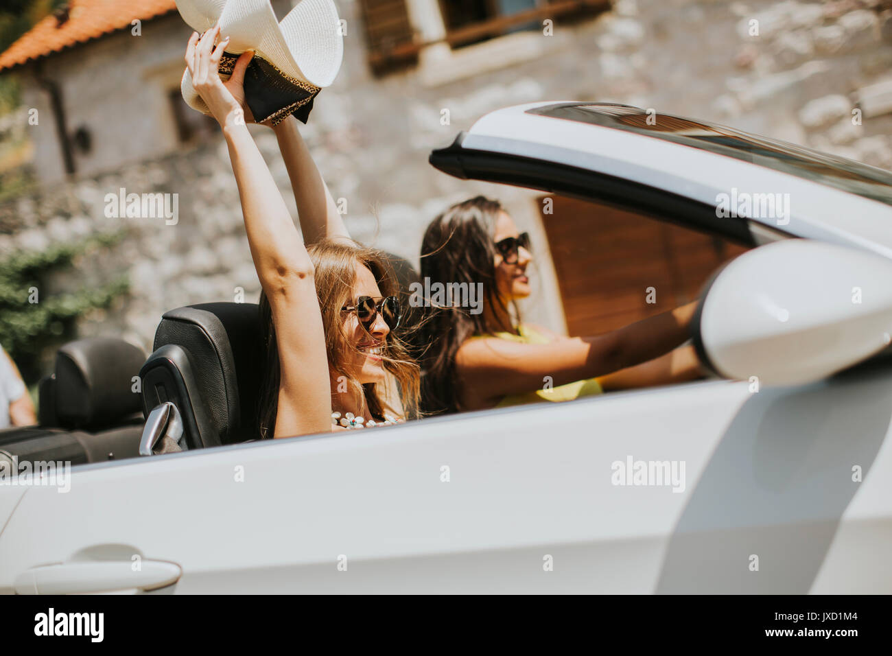 Two happy friends driving hi-res stock photography and images - Alamy