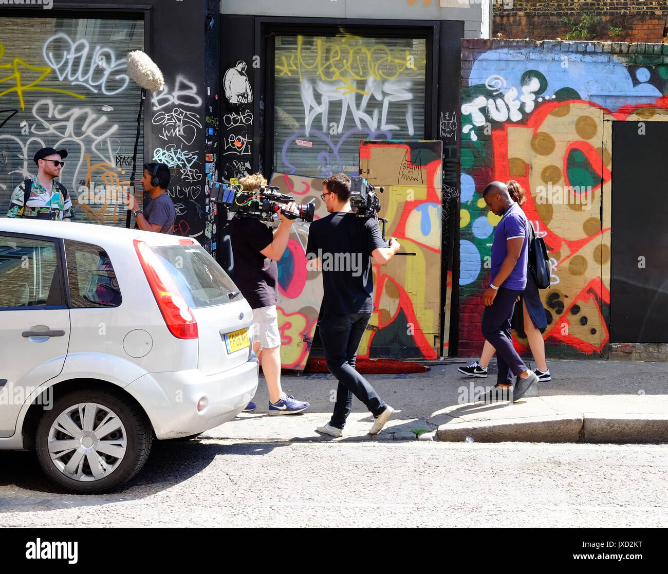 Billie JD Porter interviews an artist for television in Shoreditch, in ...