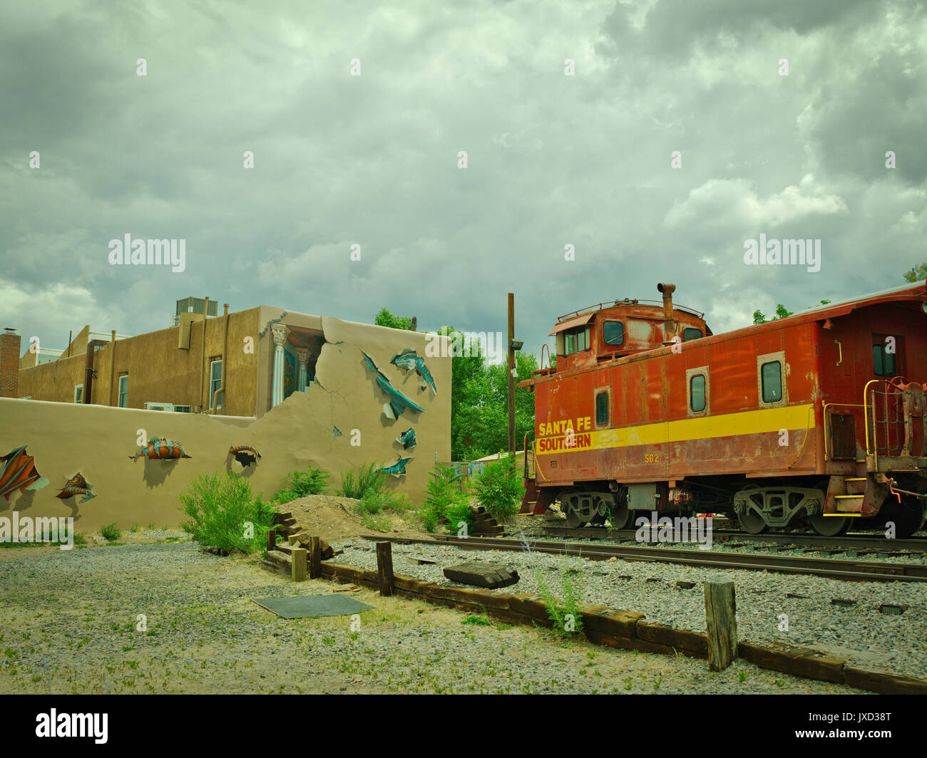 A red caboose in front of an adobe wall in Santa Fe Stock Photo - Alamy