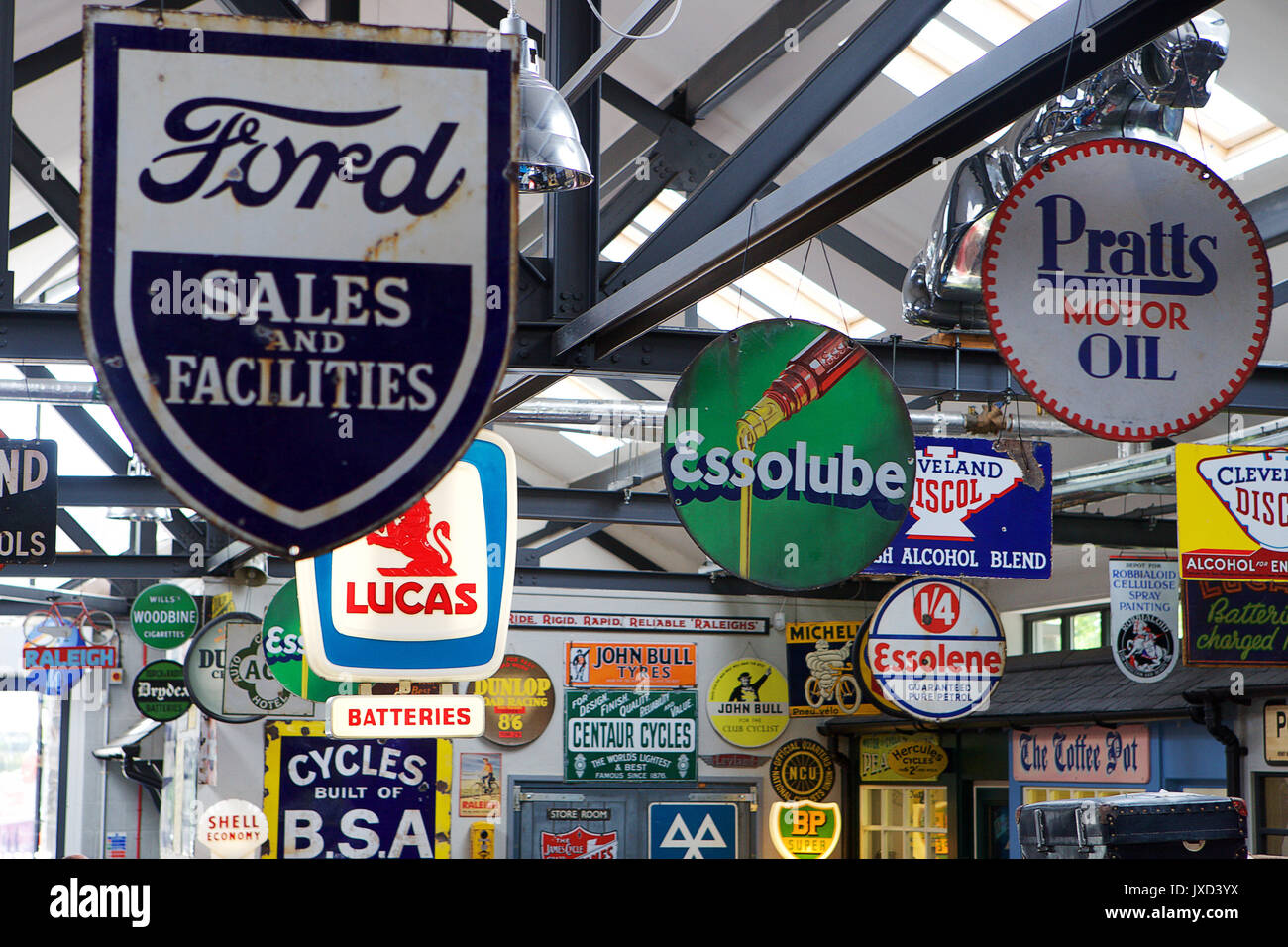 Old garage signs hanging from a roof Stock Photo - Alamy