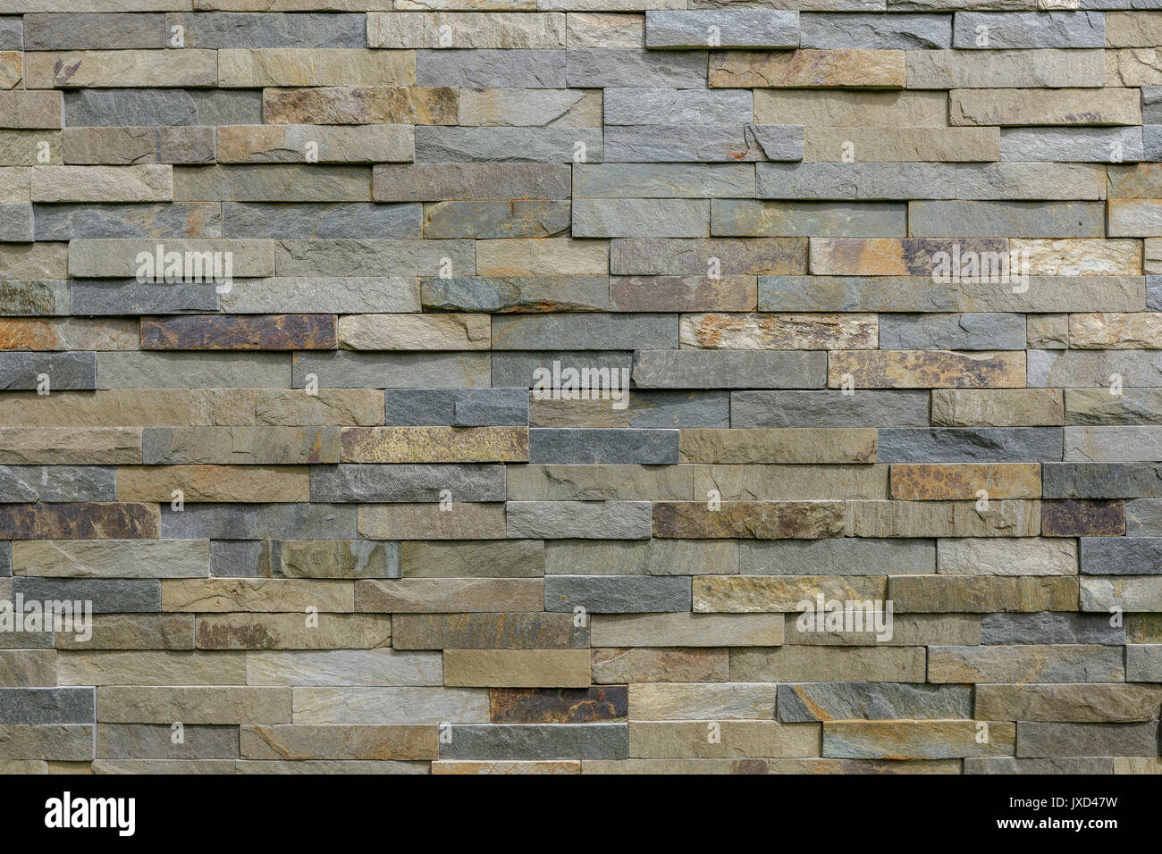 Natural stone cladding in grey, brown golden and silver colour Stock ...
