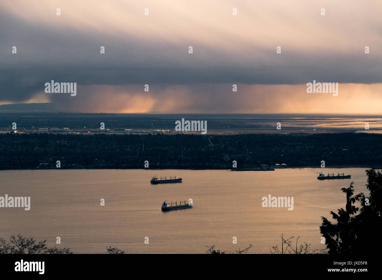 Ocean with cargo ships and rain from clouds Stock Photo - Alamy