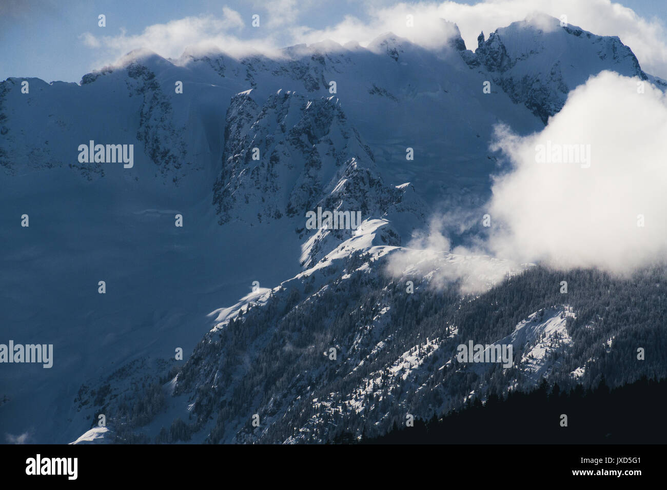 Mountains in snow and clouds in freezing weather in winter Stock Photo ...