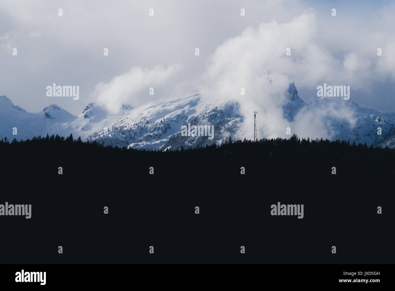 Mountains in snow and clouds in freezing weather in winter Stock Photo ...