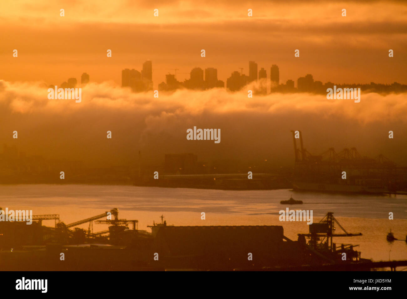 Vancouver in morning fog while sun rising behind clouds Stock Photo - Alamy
