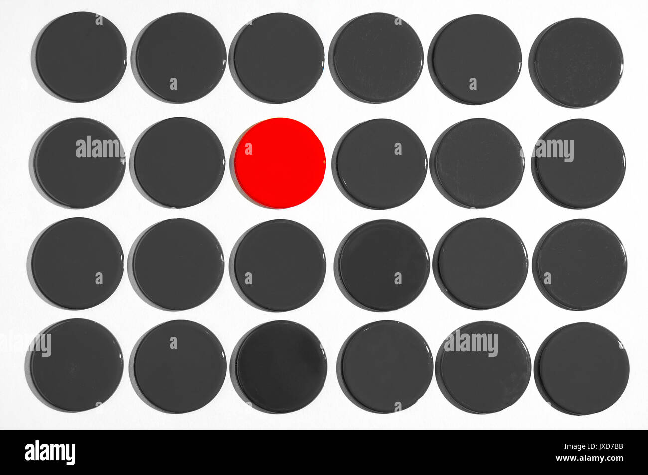 Plastic counters, one red, in srudio setting Stock Photo - Alamy