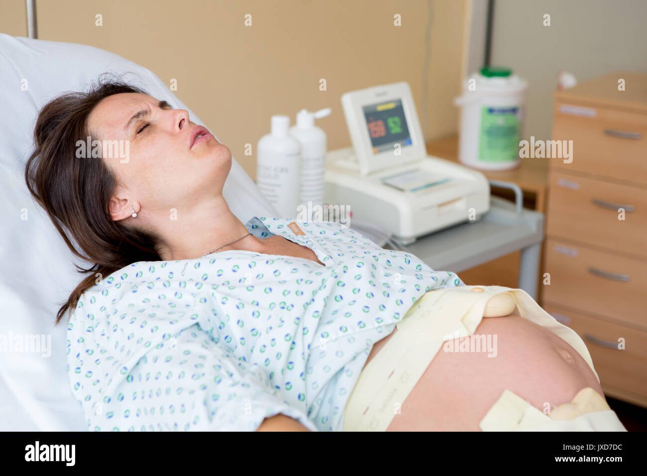 Pregnant woman in delivery room, having contractions Stock Photo - Alamy