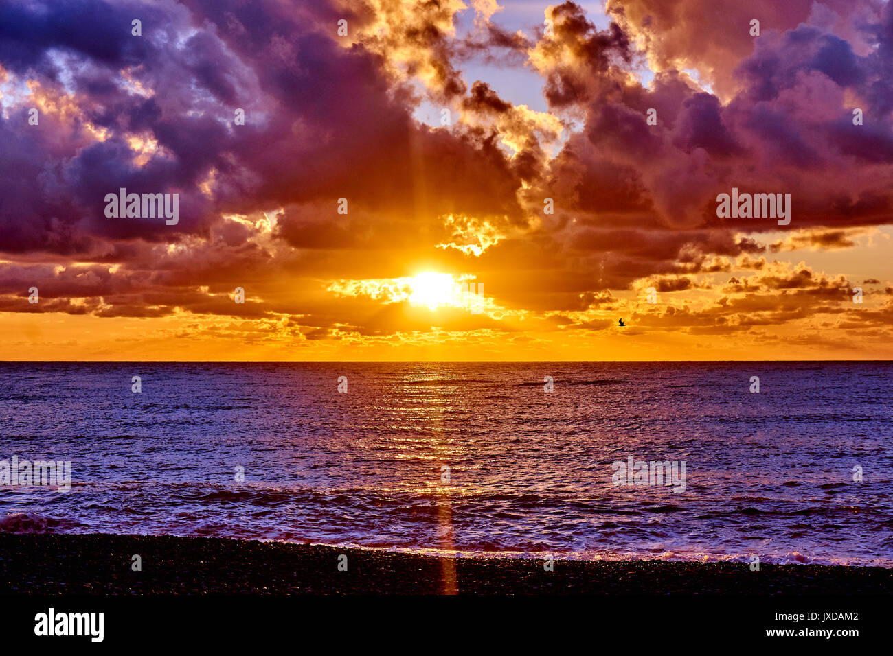 sunset over ocean. Sunset on the beach with beautiful sky. Dramatic ...