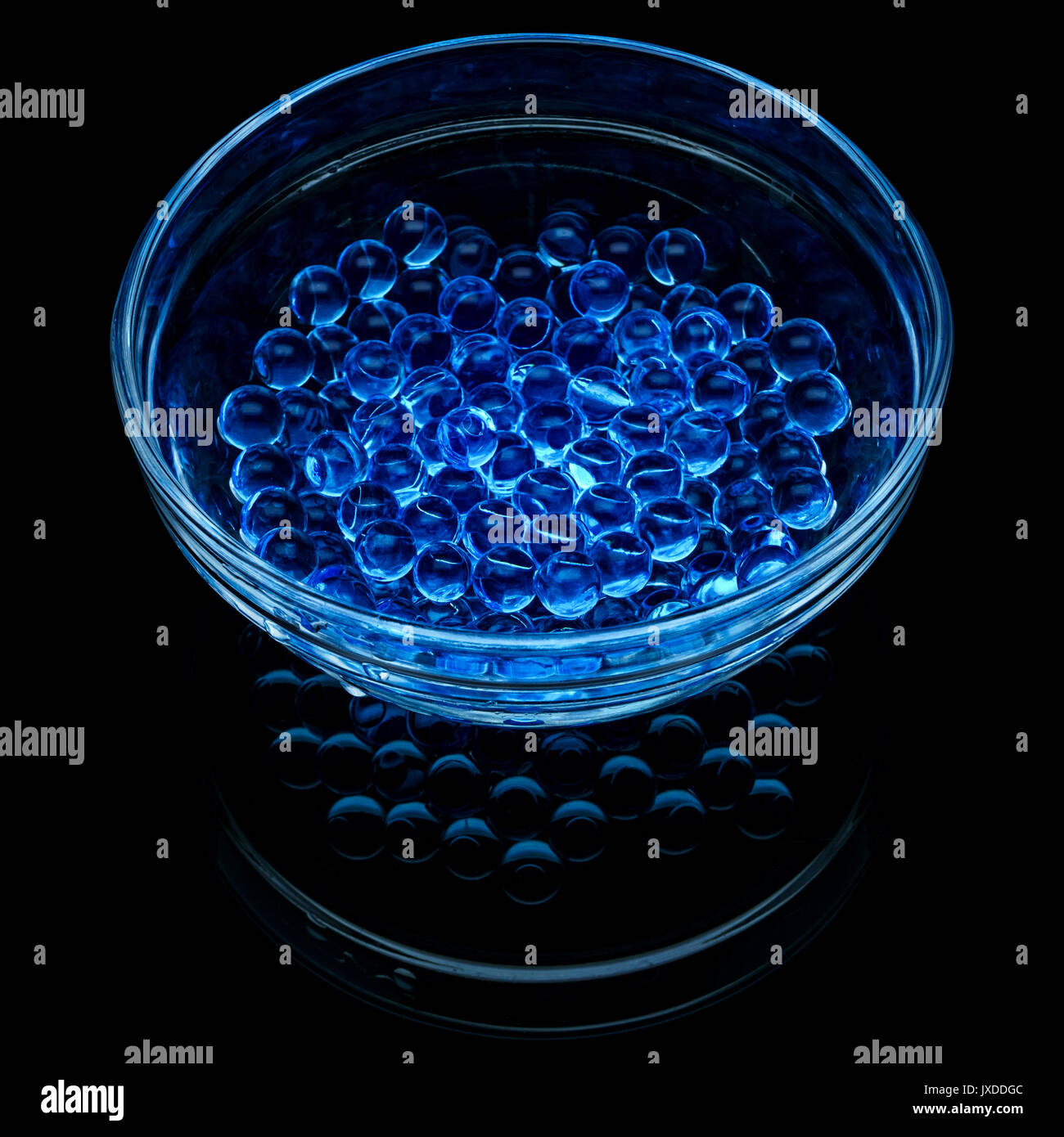 Blue hydrogel balls in a glass vase on a black background Stock Photo ...