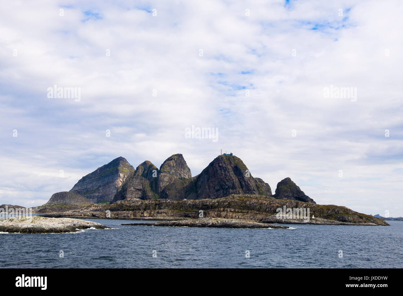 Offshore view to rocky shoreline and the five mountains of Sanna island ...
