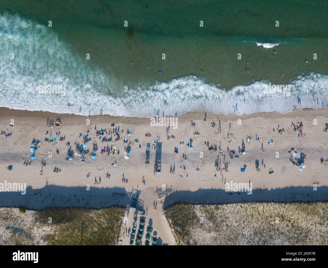 The Atlantic Ocean washes against a popular beach on Cape Cod ...