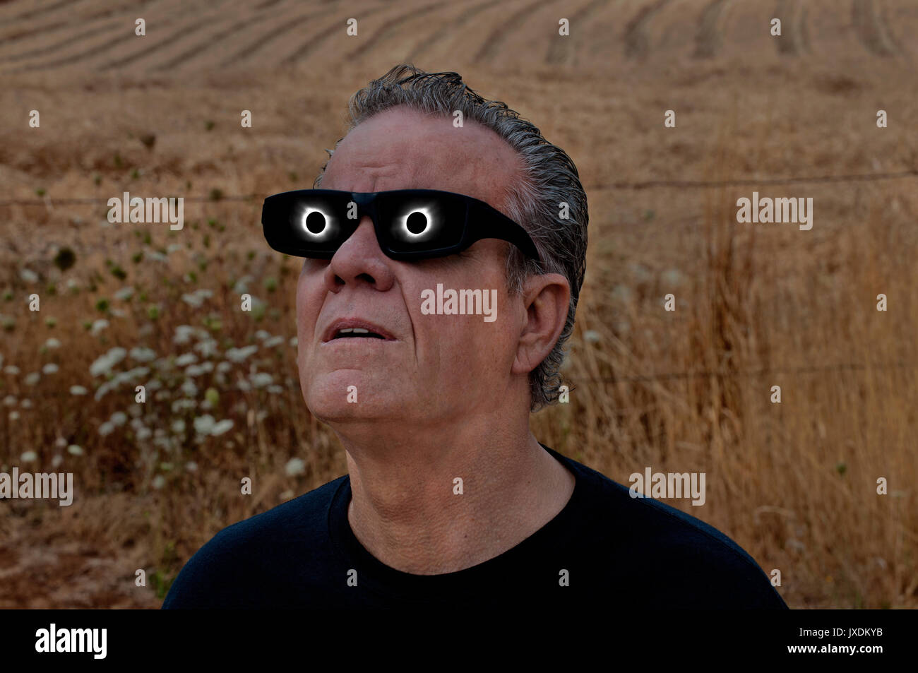 Man viewing full solar eclipse with solar glasses in country Stock ...