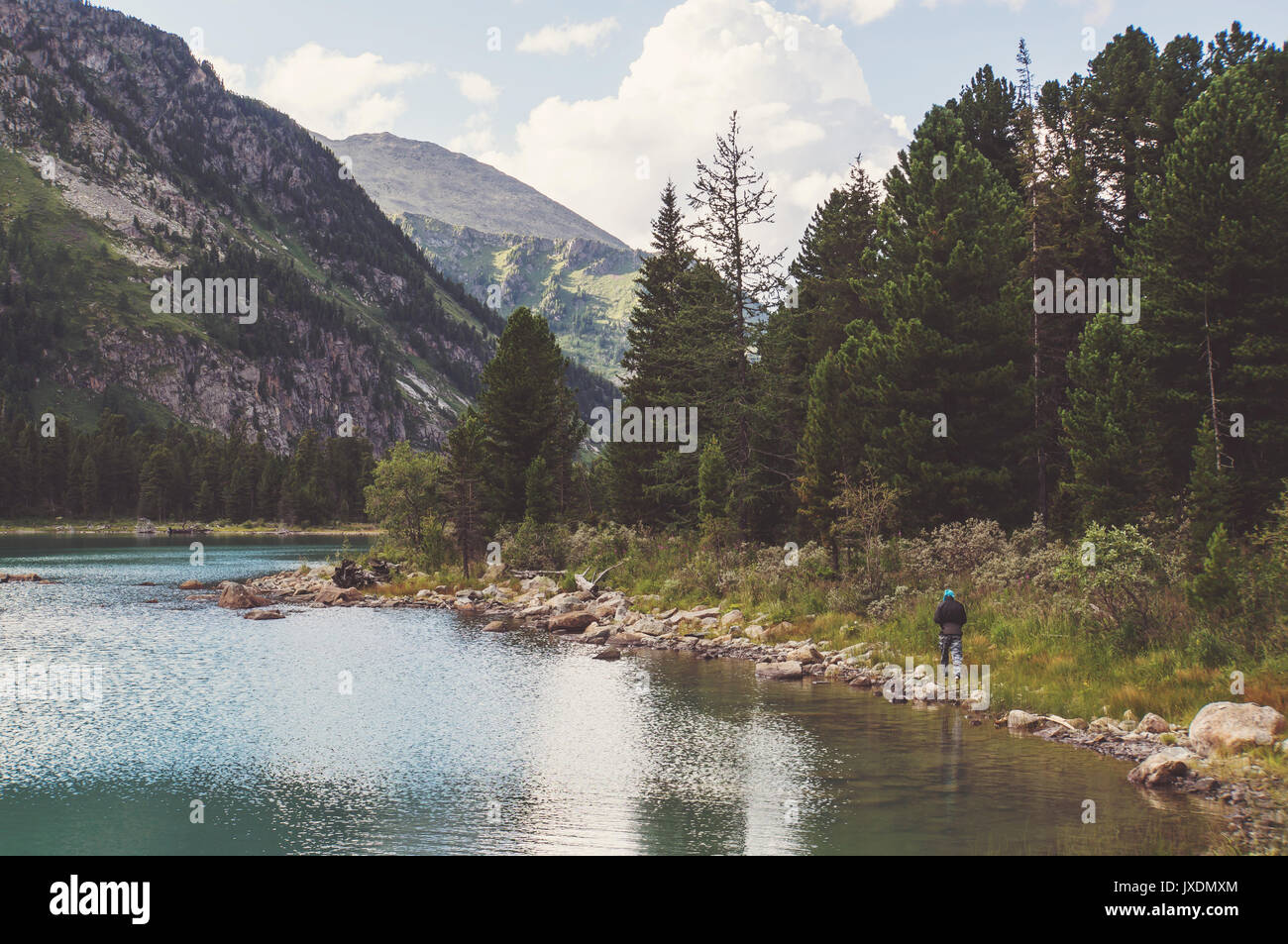 Lake with rocky ridge. Beautiful landscape. The tourist goes over the ...