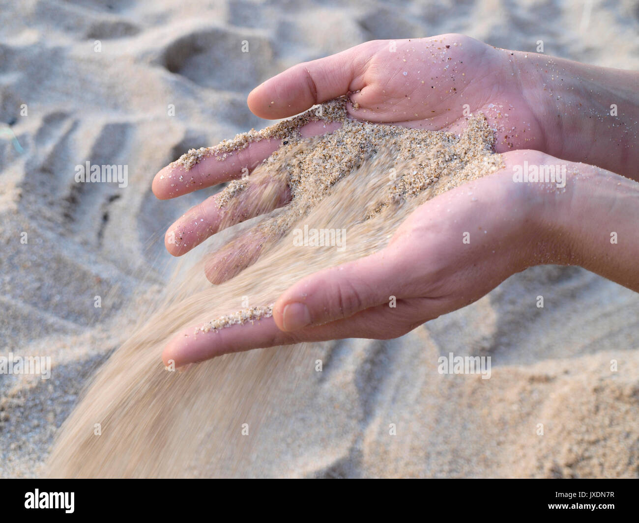 sand falling from hands Stock Photo - Alamy
