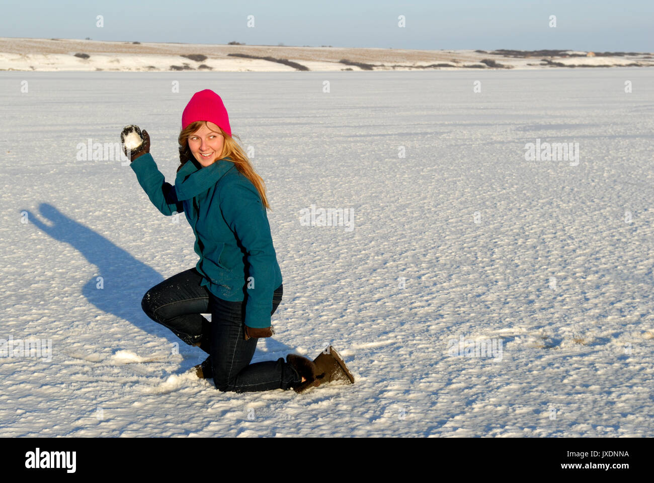 Playful Winter Woman ready to throw Snowball Stock Photo - Alamy