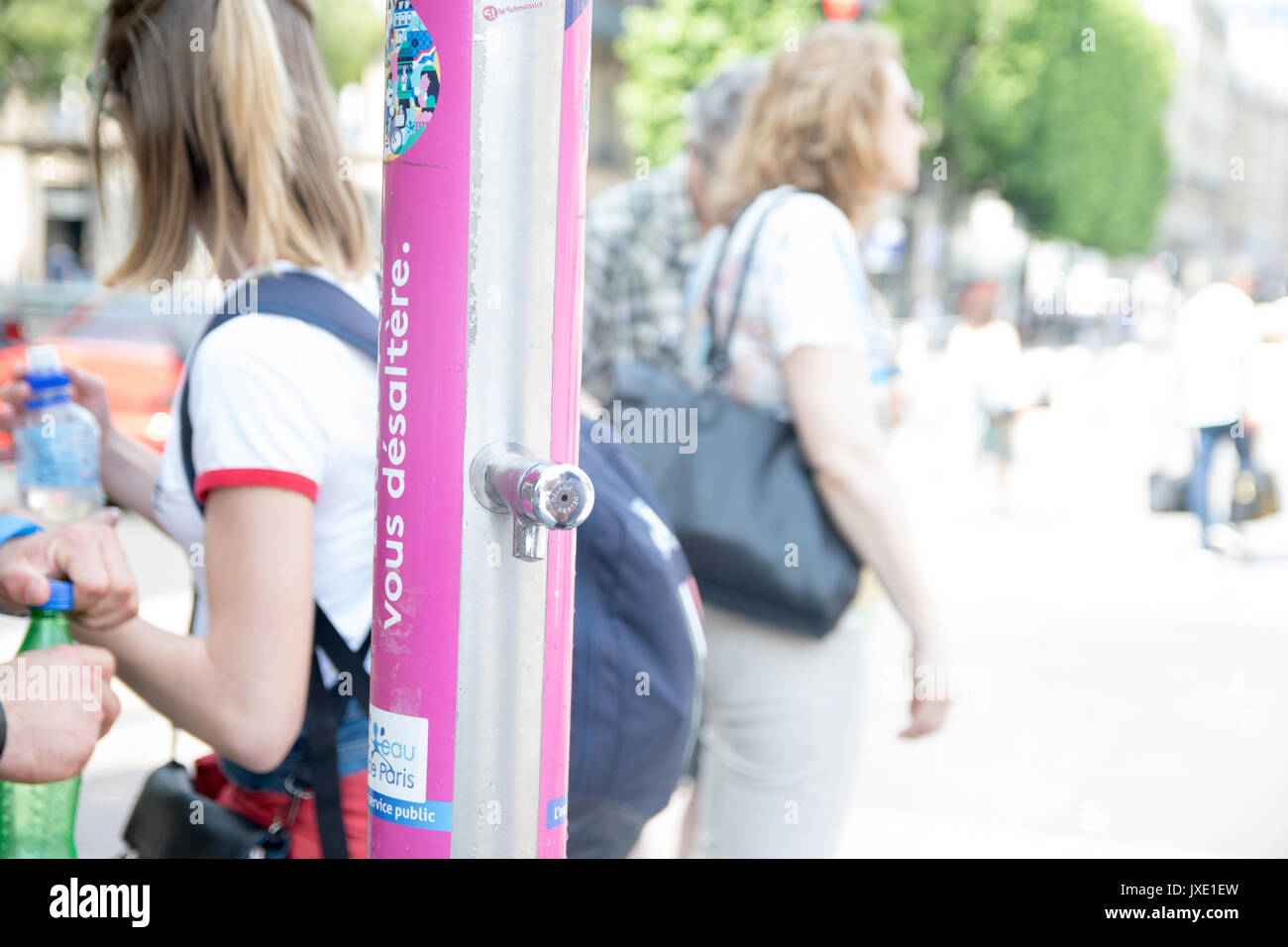 People filling up water in a plastic bottle at a public water fountain ...