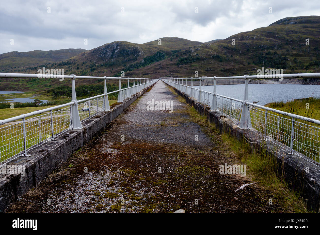 Concrete walkway leading on top of hydroelectric dam wall in Scottish ...