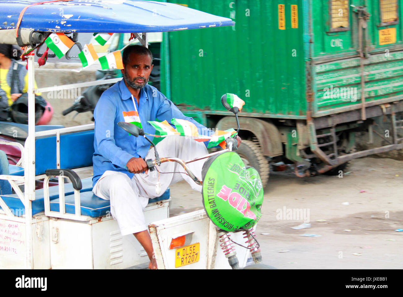 Electric auto rickshaw with Indian National Flag Tricolor decor on his ...