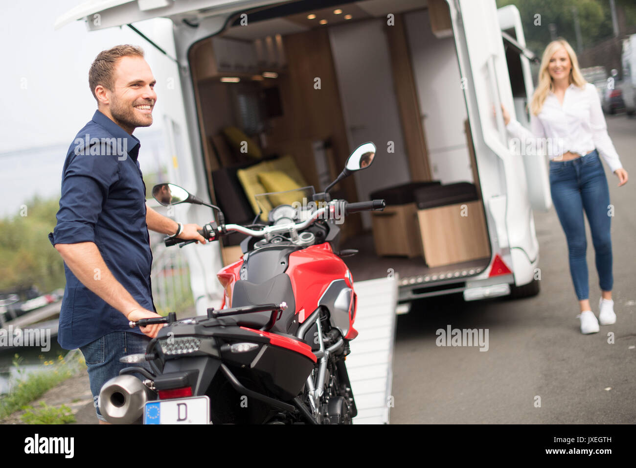 Duesseldorf, Germany. 16th Aug, 2017. Model Stefan pushes a motorbike ...