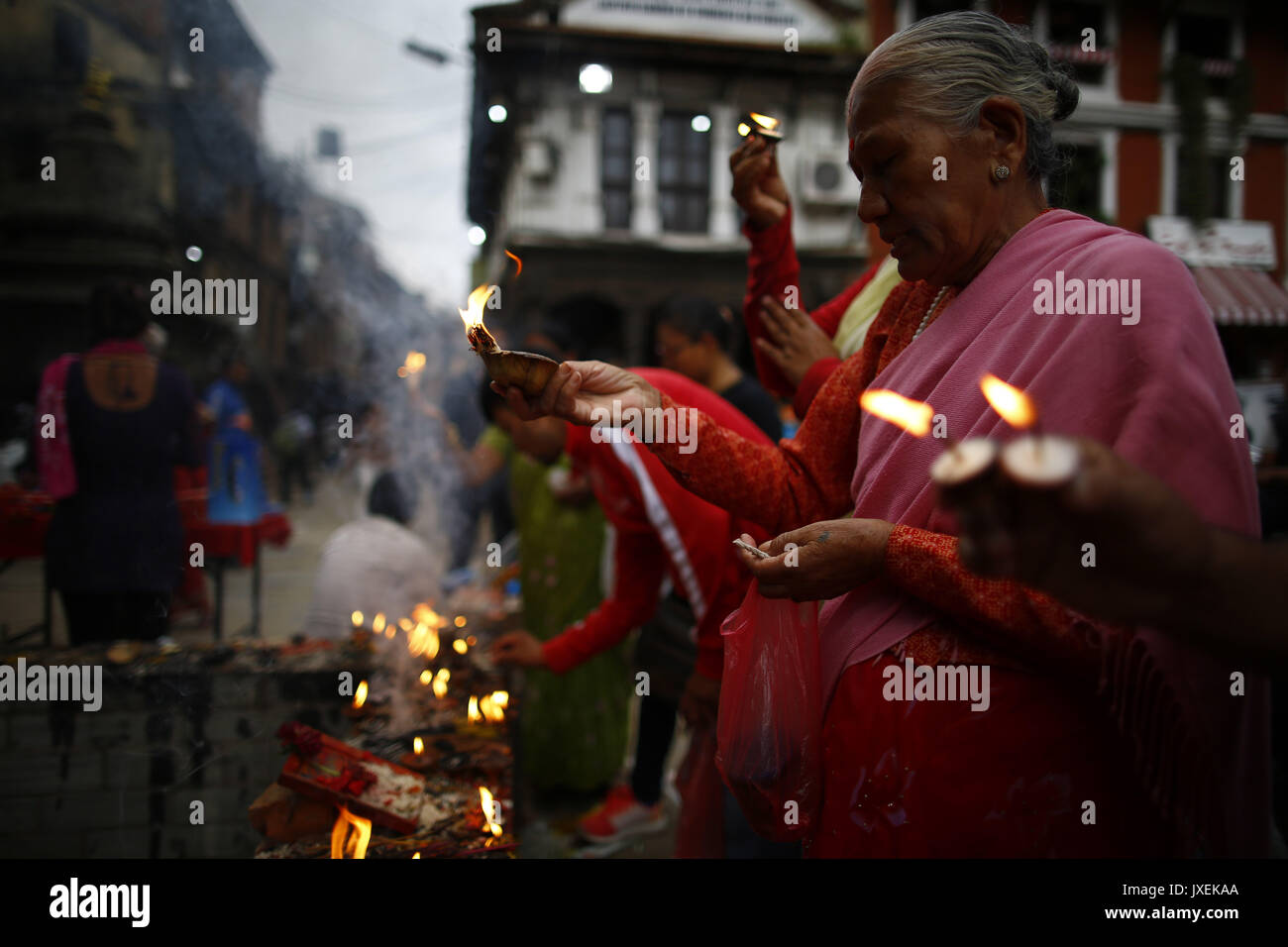 Lalitpur, Nepal. 16th Aug, 2017. Devotees light butter lamps to worship ...