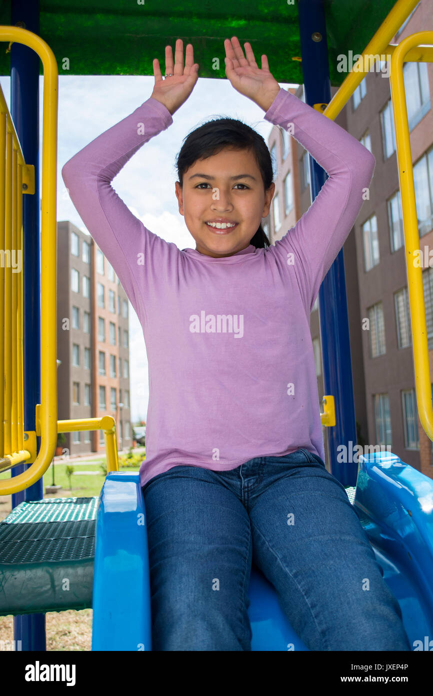 Small child on slide in an outdoors playground Stock Photo - Alamy