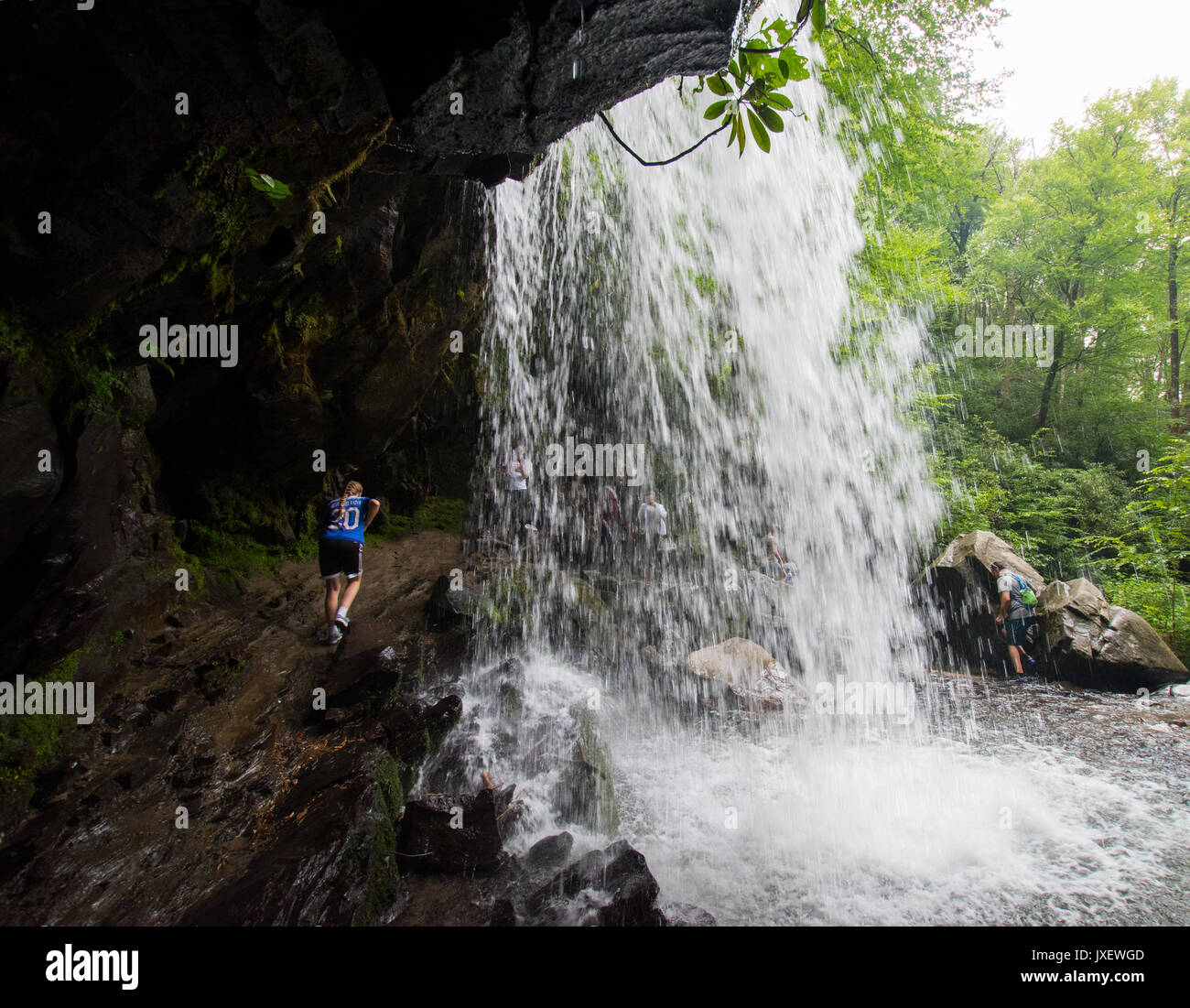 Little girl walking beneath a waterfall in the Smoky Mountains Stock ...